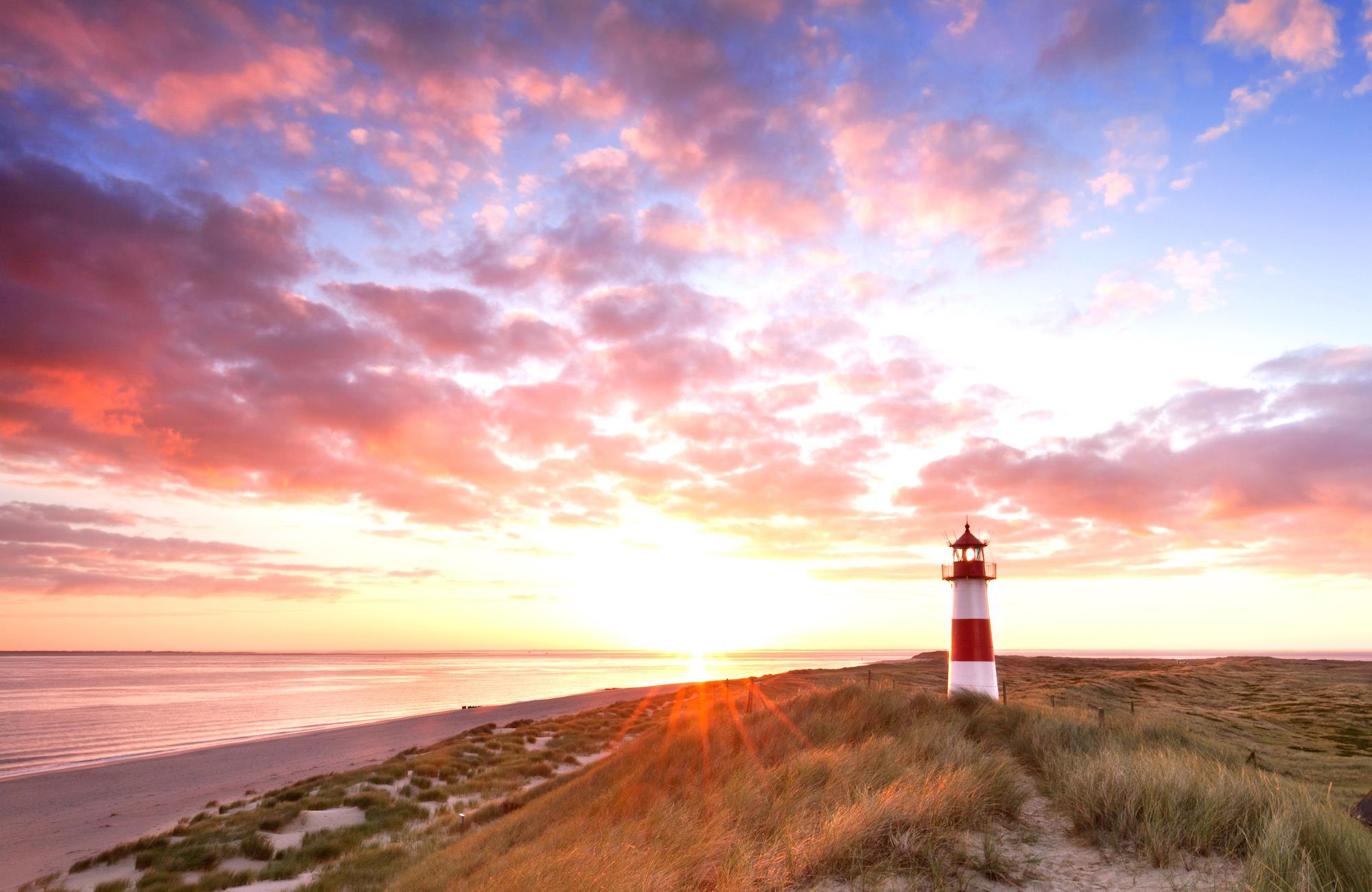Radiant Sunrise Over Coastal Lighthouse HD Wallpaper