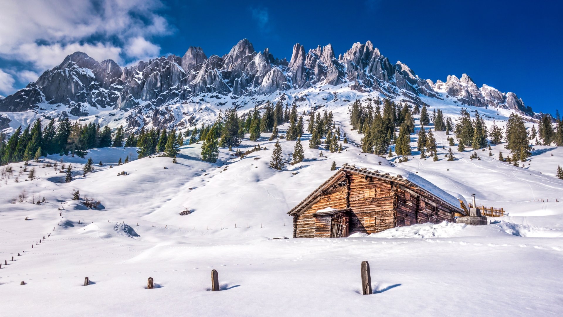 4K Ultra HD Winter Cabin Amidst Snowy Mountain Peaks