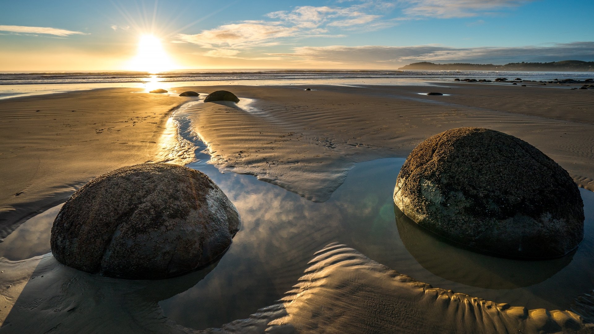 Sunlit Stones on Golden Sand — 4K Coastal Beach Wallpaper