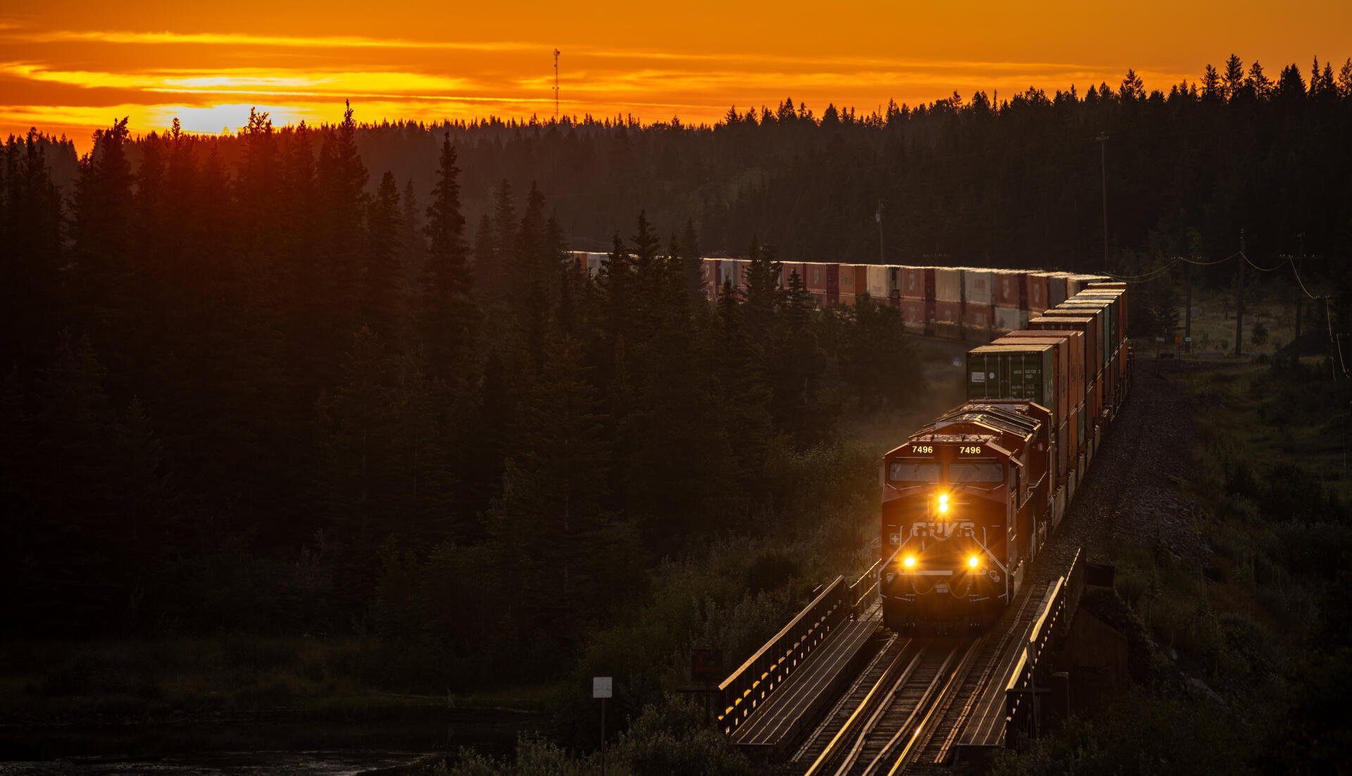 Twilight Freight — 5K Ultra HD: Train Crossing Sunset Rails by Ryan Gaynor