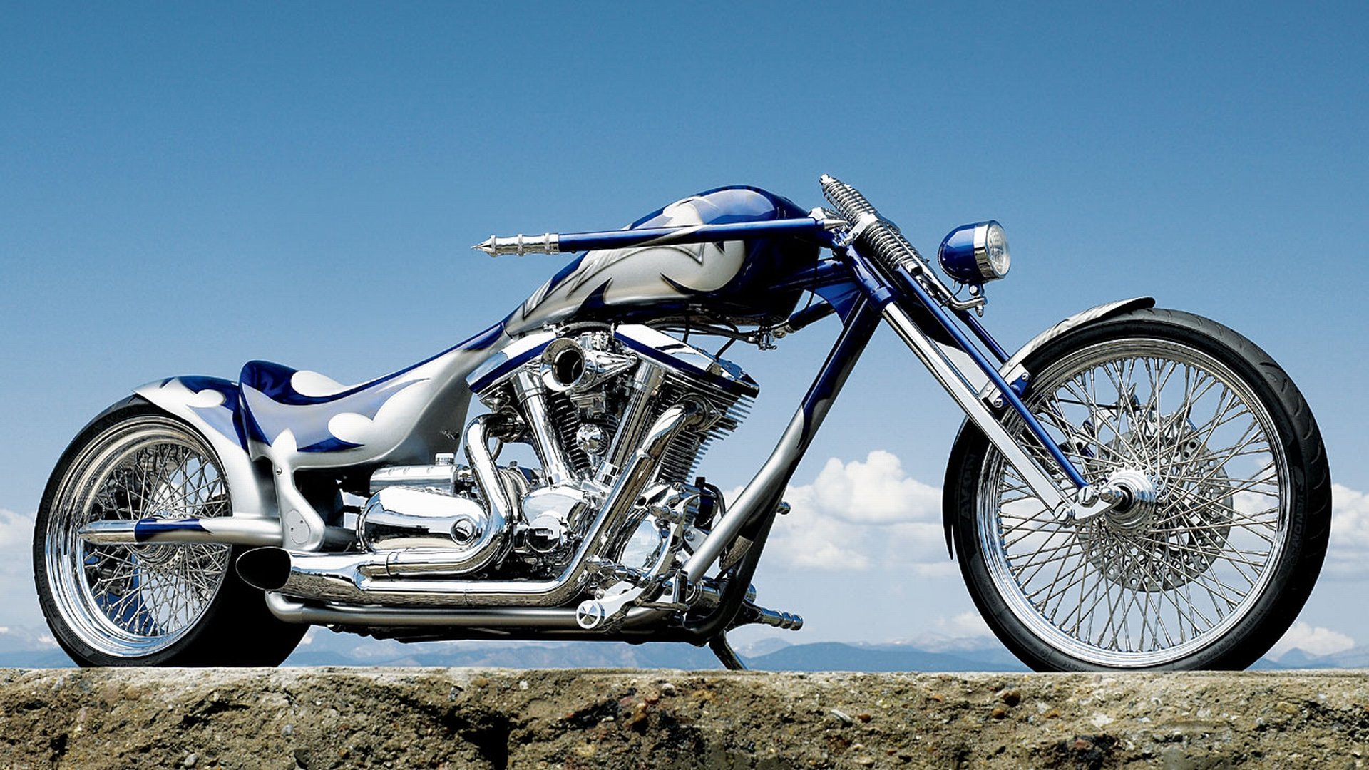 HD Motorcycle Marvel: Sleek Chrome Ride Against Clear Blue Sky