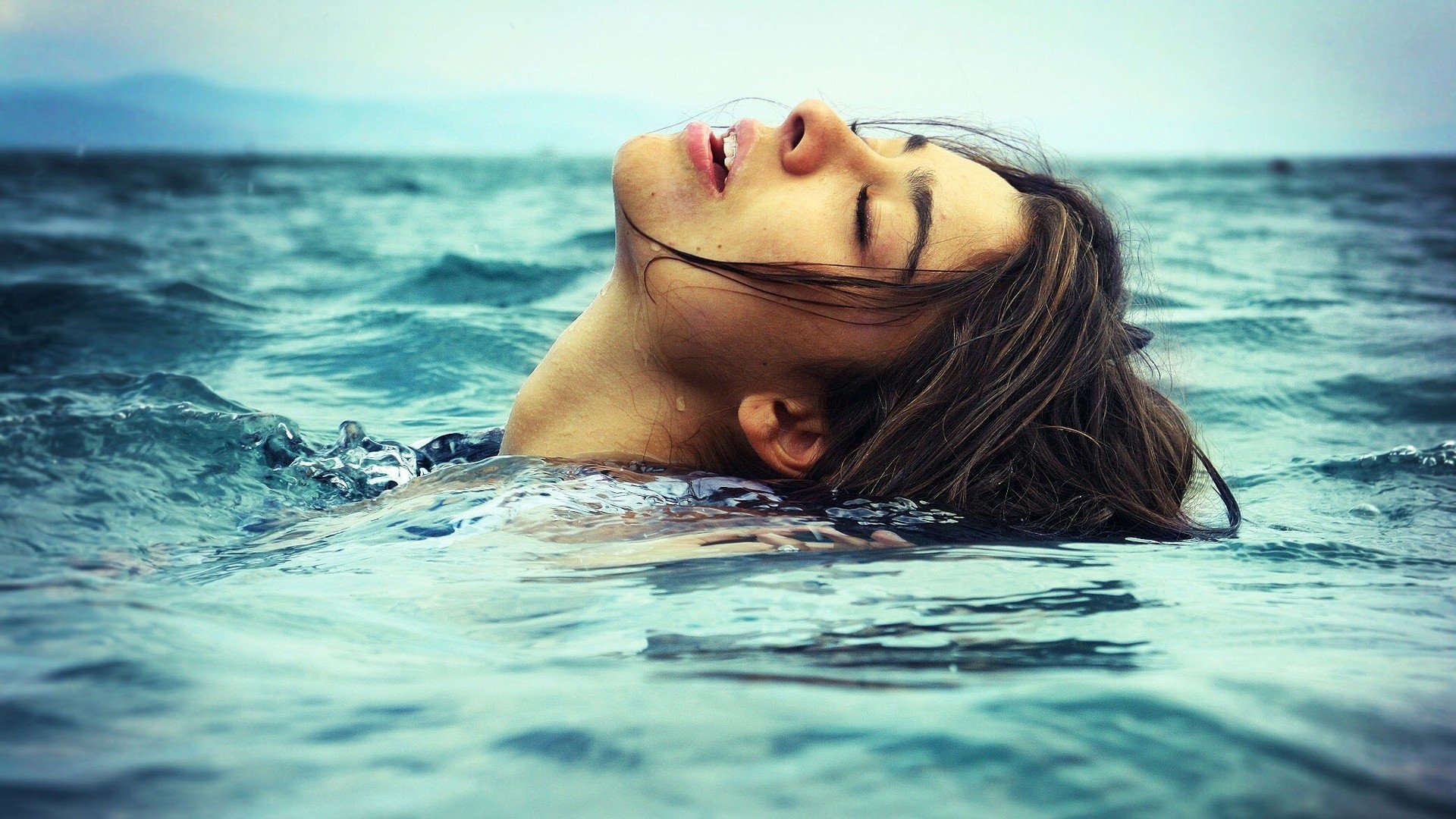 Serene Waves: Woman Embracing the Ocean's Calm Essence