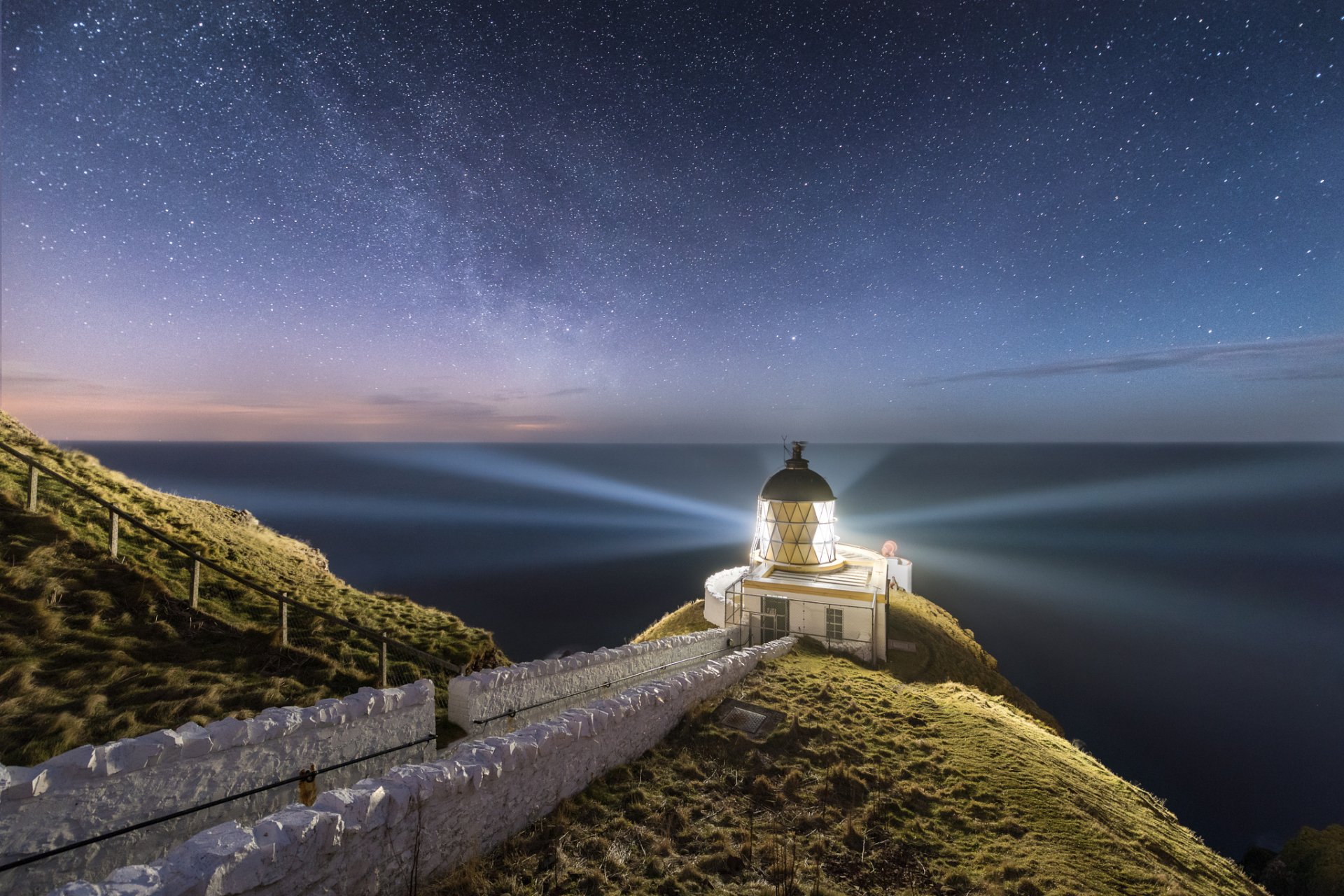 Guiding Light Beneath a Starry Night Sky Over the Ocean – HD Wallpaper ...