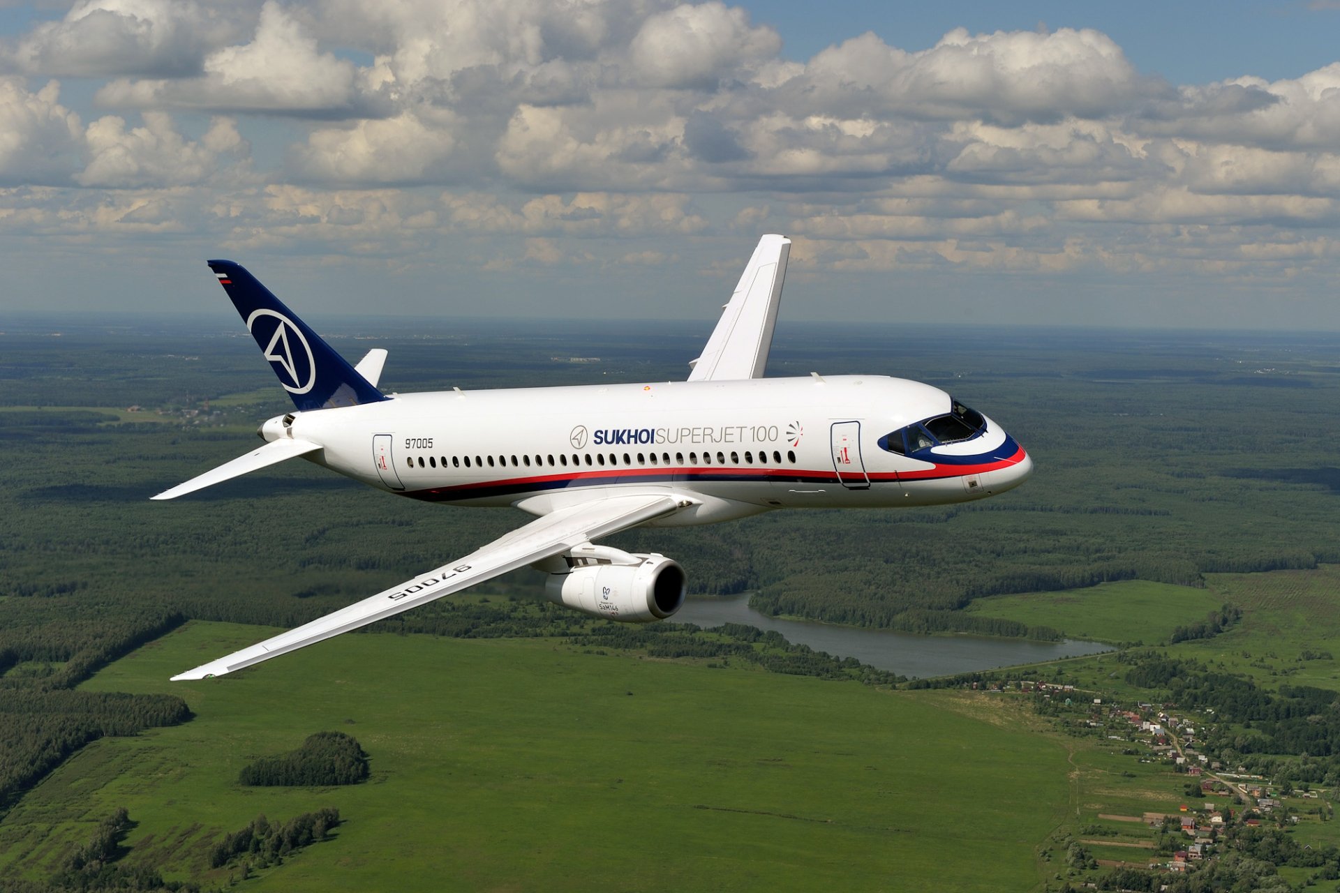 Sukhoi SuperJet 100 Soaring Through Clouds – HD Airplane Wallpaper